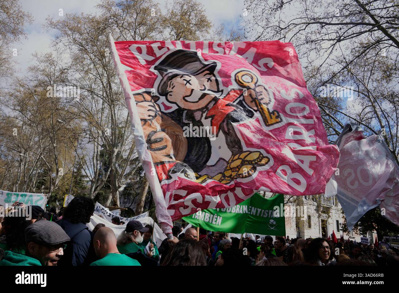 People march with a flag depicting a rich banker during a demonstration ...