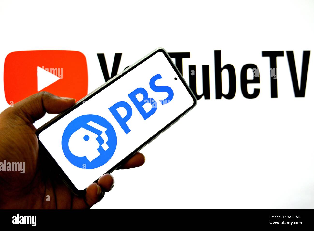 In this photo illustration, a PBS logo is seen displayed on a ...