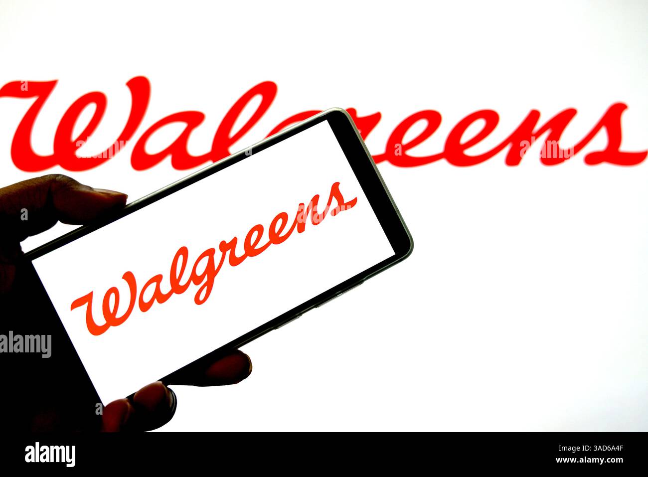 In this photo illustration, a Walgreens logo is seen displayed on a ...
