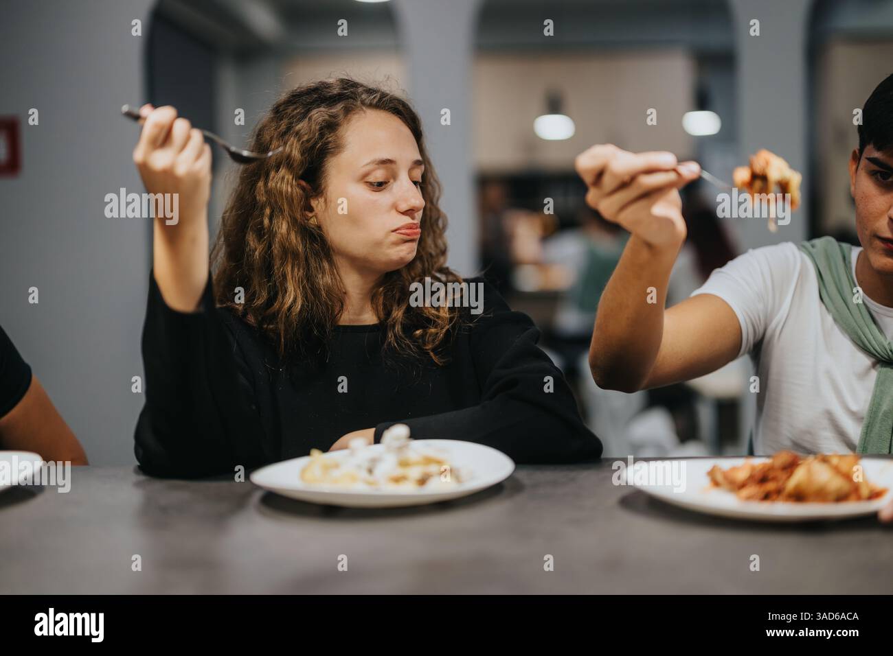 Students dining together in a school cafeteria, sharing food and ...