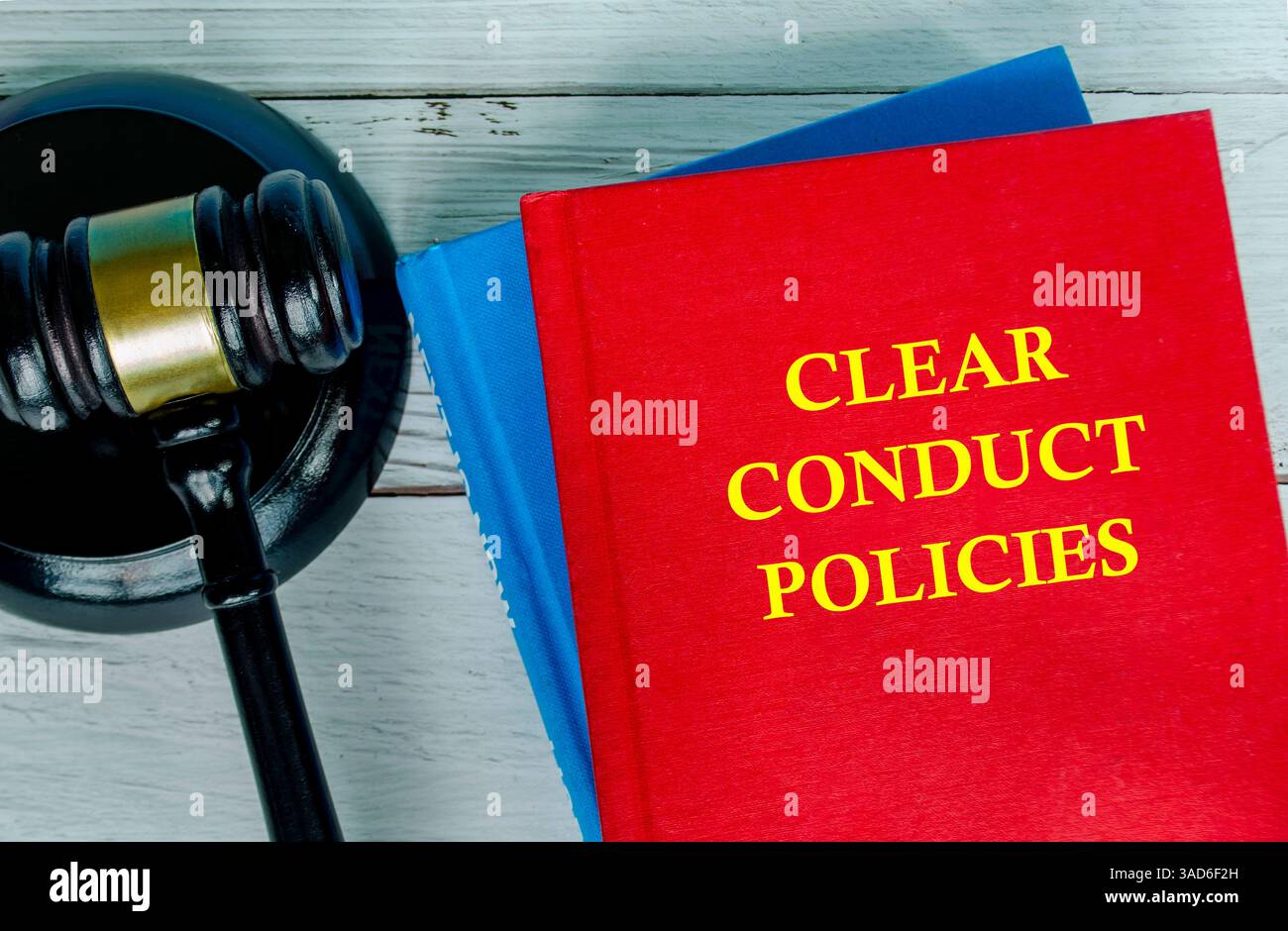 Top view of Clear Conduct Policies text on red cover book with gavel ...