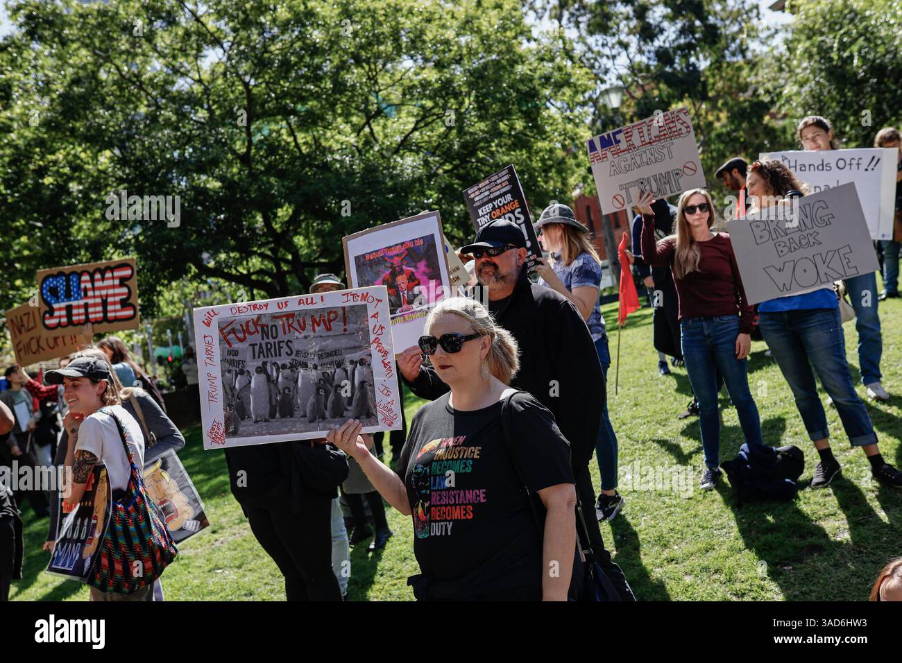 (EDITORS NOTE: Image contains profanity) Protesters hold placards ...