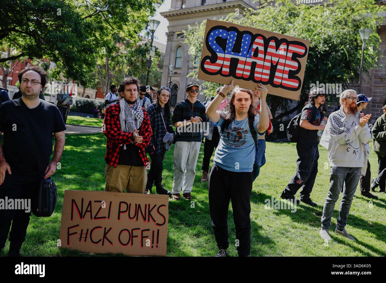 (EDITORS NOTE: Image contains profanity) Protesters hold placards ...