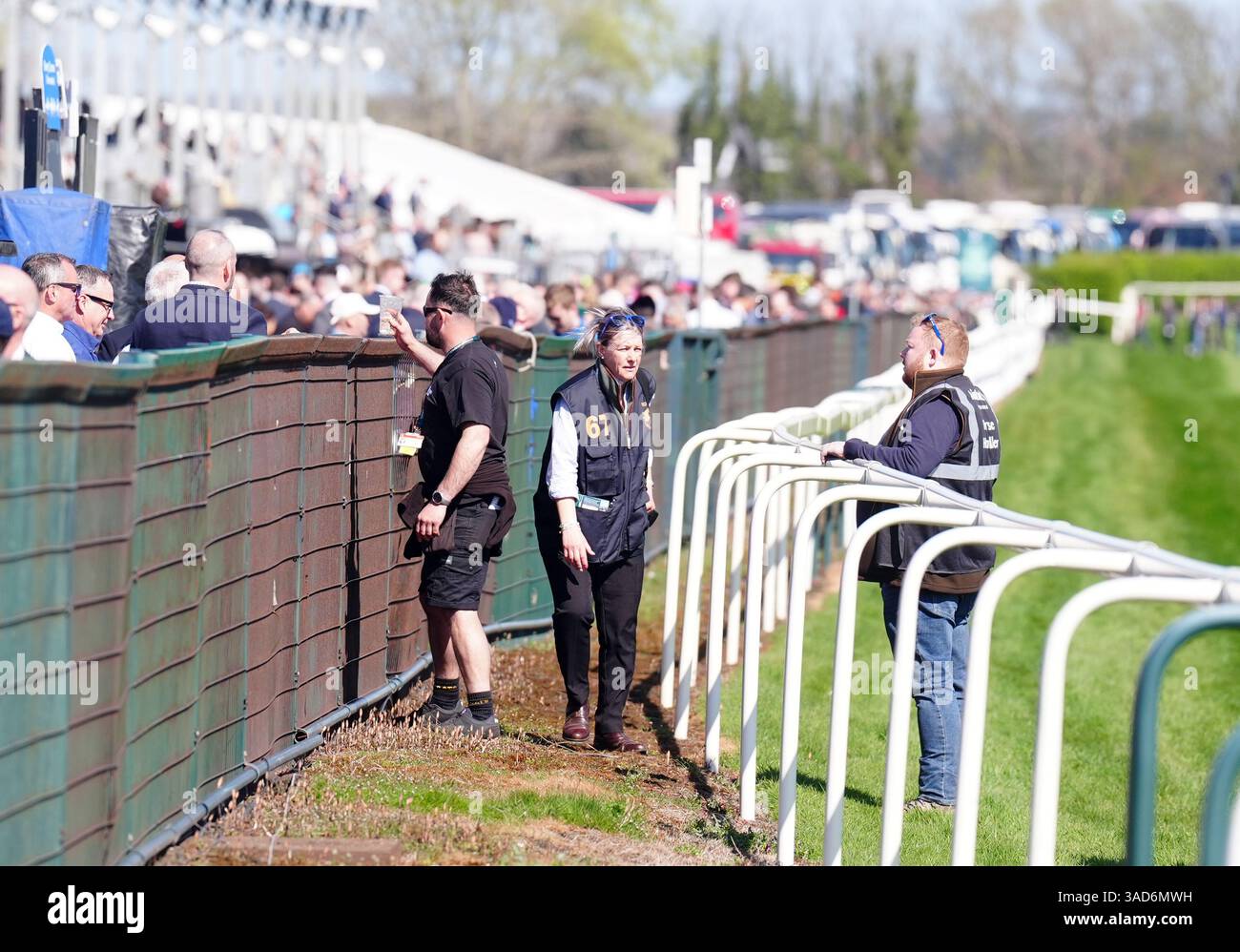 Ground staff retrieve a plastic cup from the track after it was thrown ...