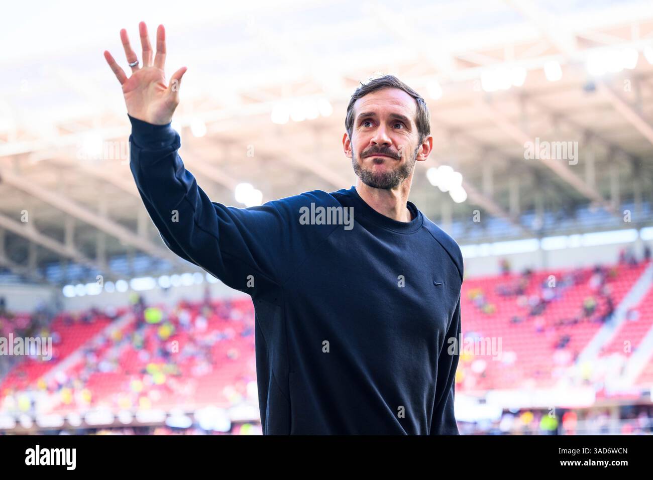 Freiburg coach Julian Schuster waves to fans before the German ...