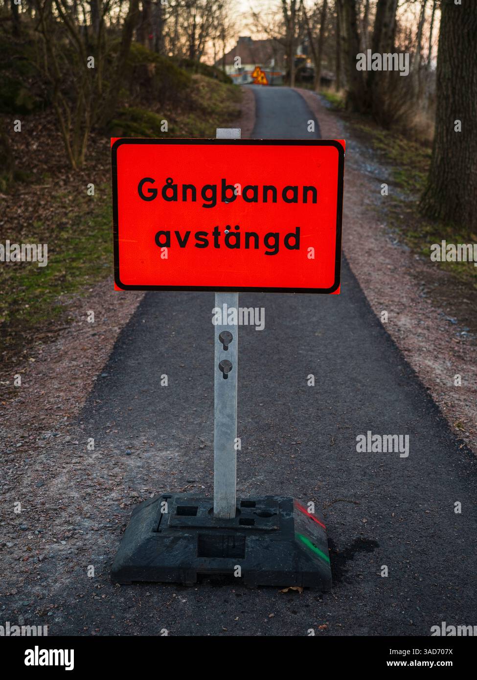 A bright red sign stands on a walkway in Gothenburg, Sweden, clearly ...