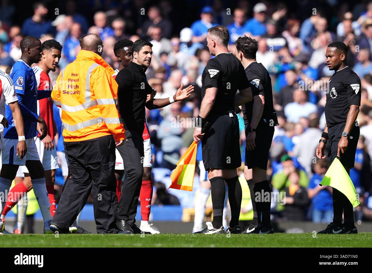 Arsenal manager Mikel Arteta (centre left) attempts to pull his players ...