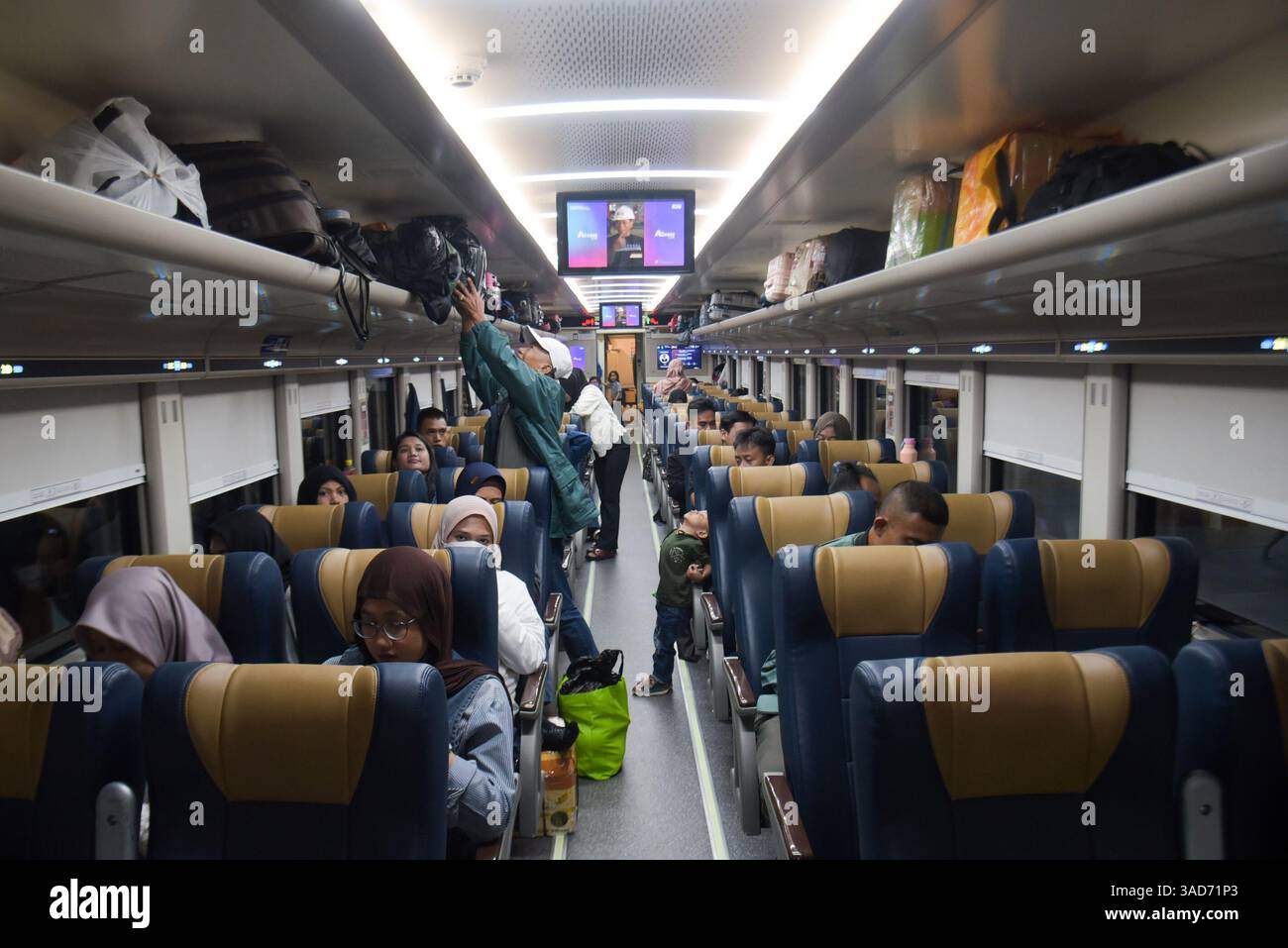 April 5, 2025, Bandung, West Java, Indonesia: A passenger stores his ...