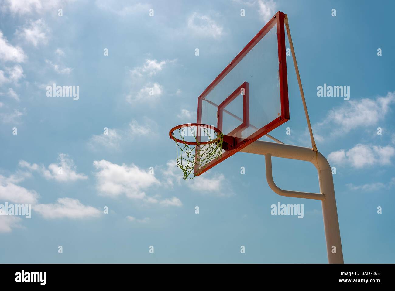 Outdoor orange basketball hoop with blue cloud sky. High quality photo ...
