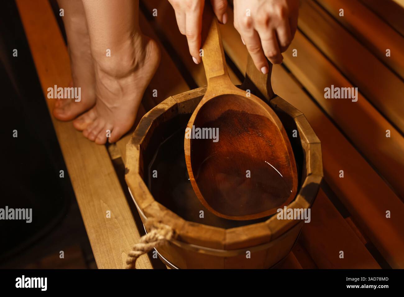 Woman with bucket of water in sauna, closeup Stock Photo - Alamy