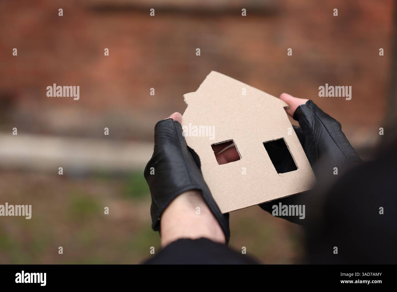Homeless man with carton house figure outdoors, closeup Stock Photo - Alamy