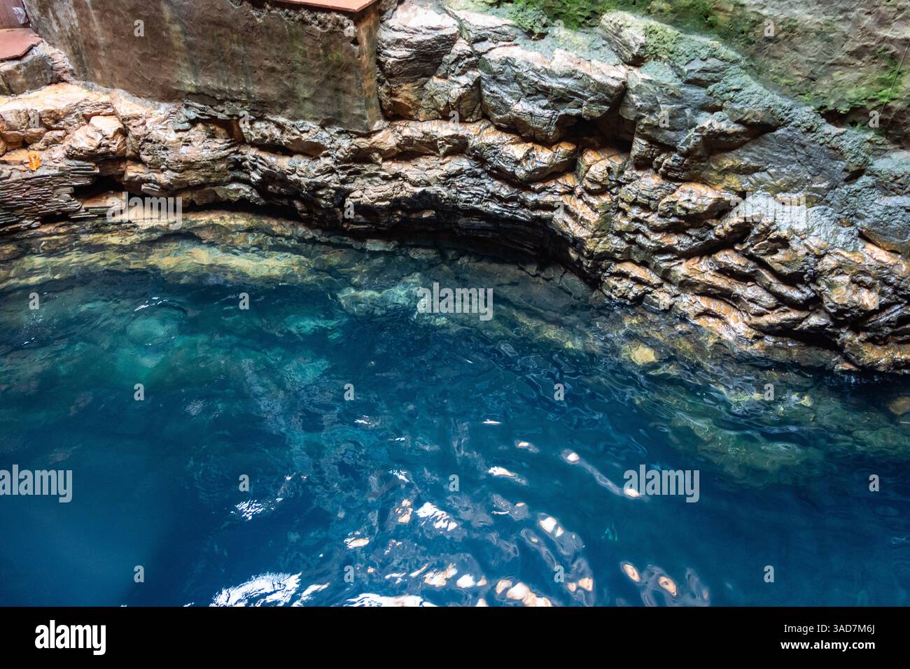 This is naturally occuring blue water in a cave at a location called ...