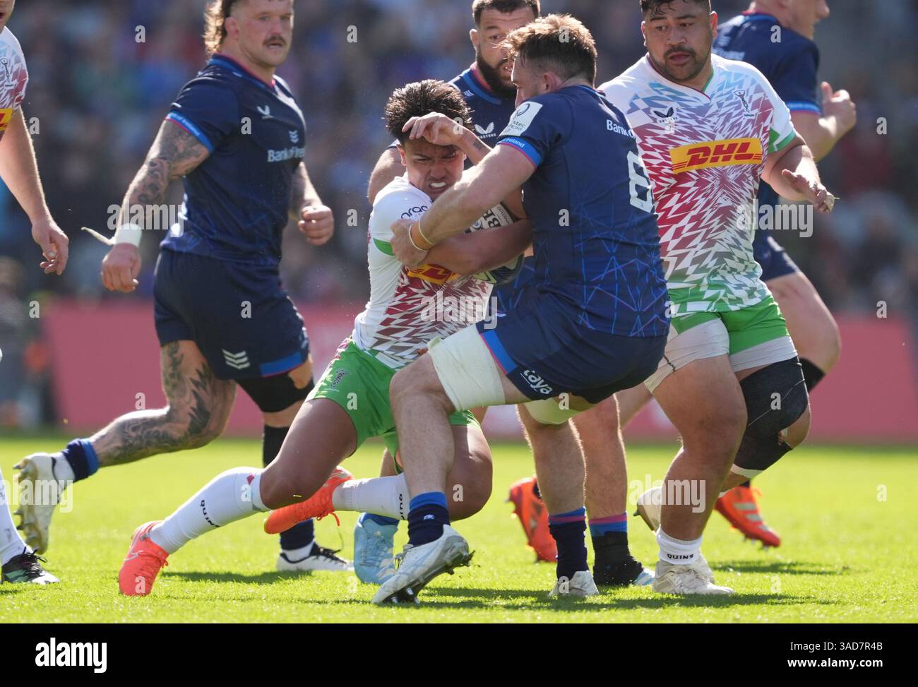 Harlequins' Marcus Smith (left) is tackled by Leinster's Jack Conan ...