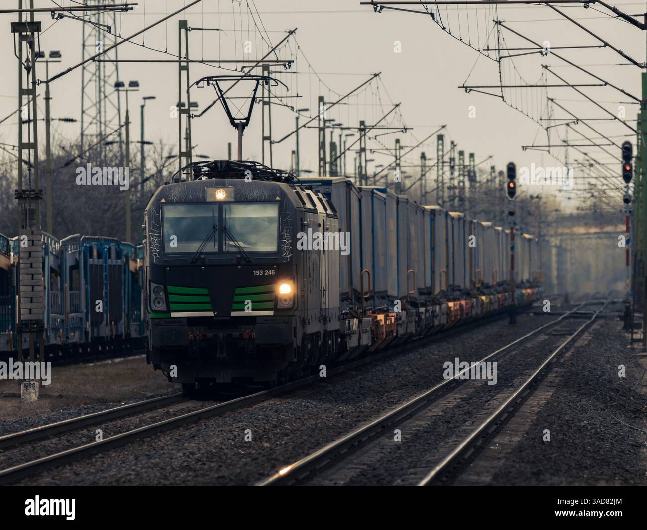 Freight train passing through rail yard Stock Photo - Alamy