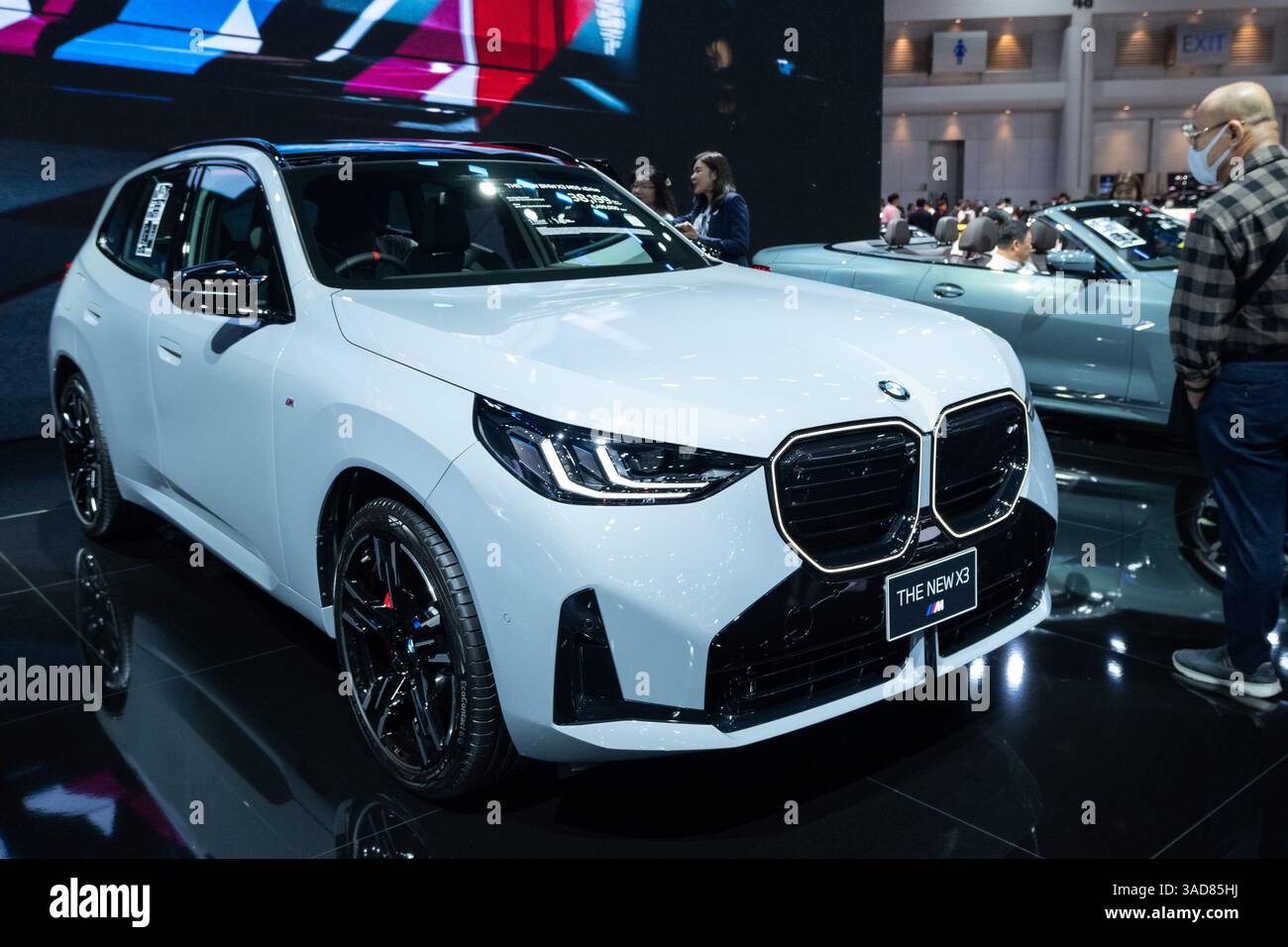 Visitors inspect a BMW New X3 car during the 46th Bangkok International Motor Show. The 46th ...