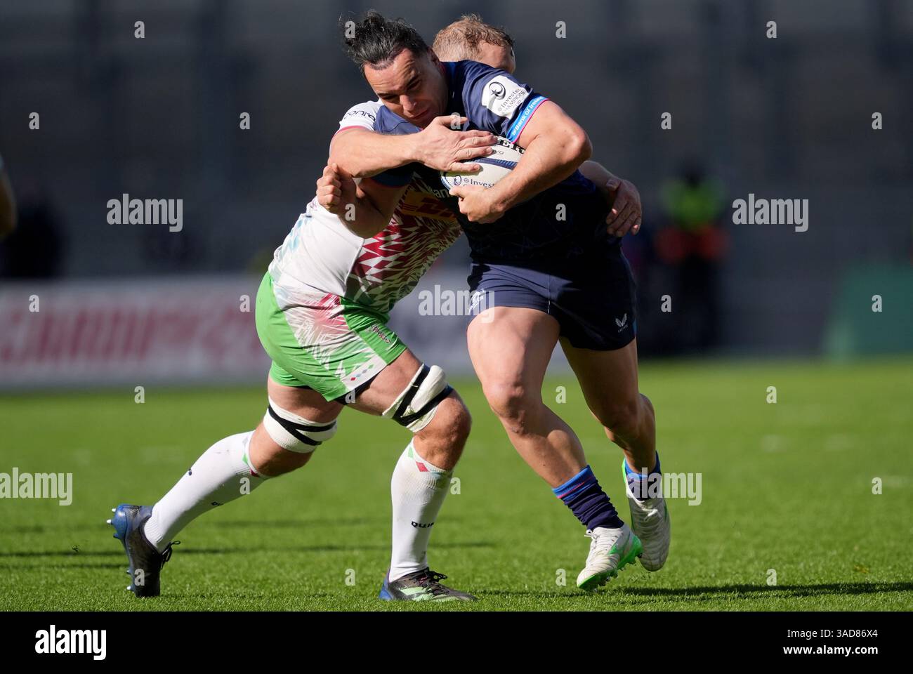 Leinster's James Lowe (right) is tackled by Harlequins' Joe Launchbury ...