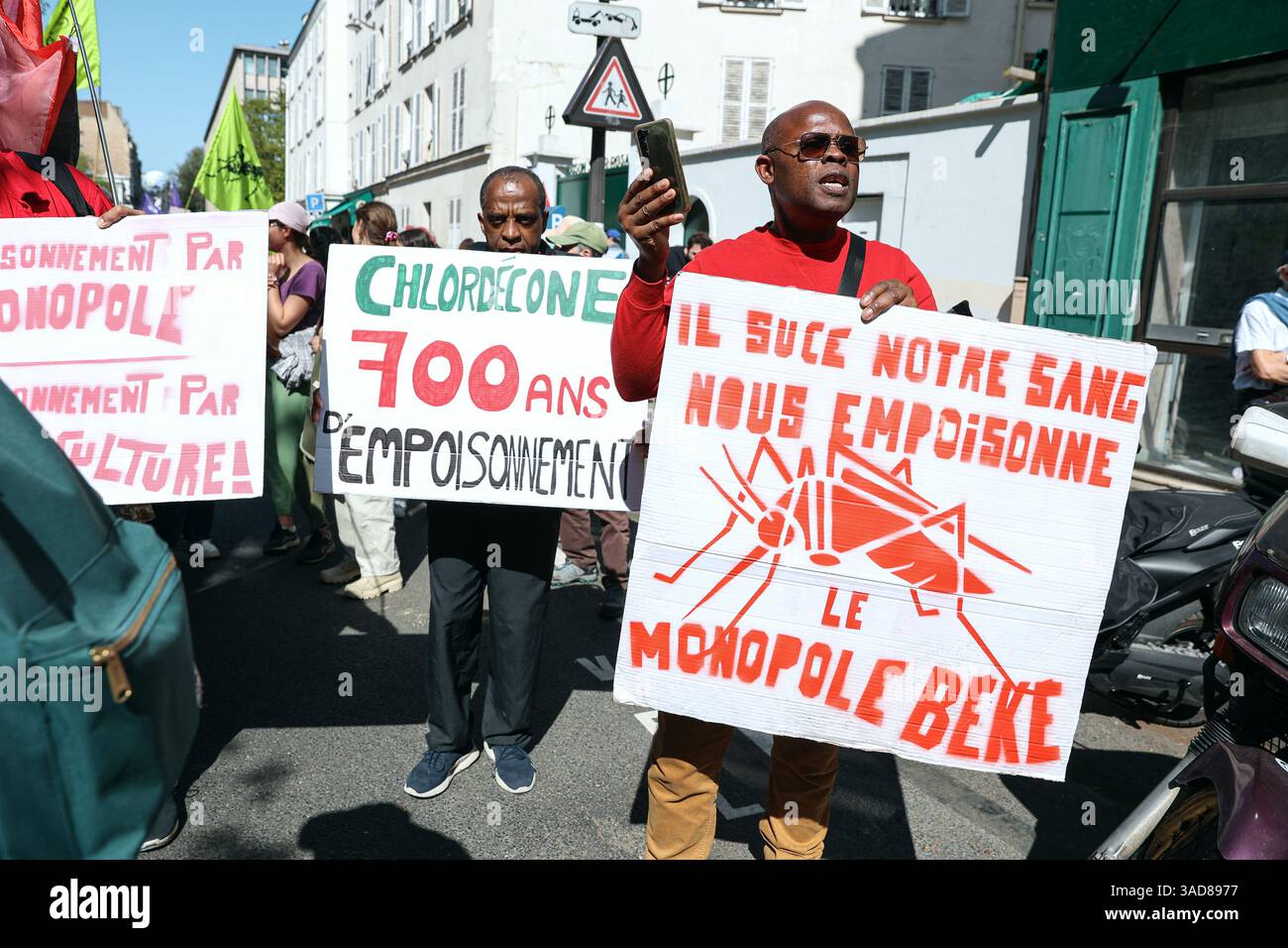 Paris, France. 05th Apr, 2025. Two protesters in a procession holding ...