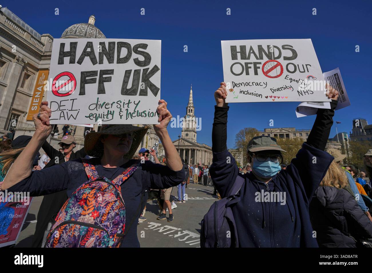 Protesters hold signs as they join a 