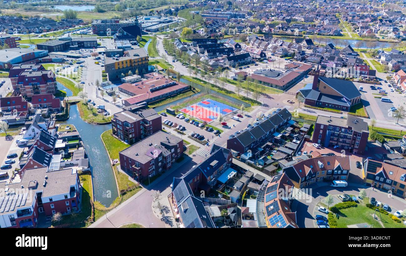 This aerial view captures a modern Dutch suburban area filled with ...