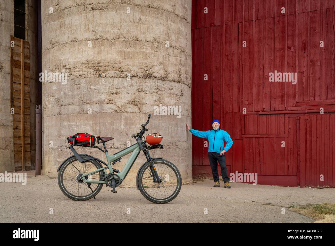 senior male cyclist with a touring electric bike is taking a rest break ...