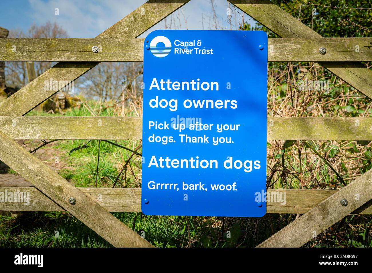 A spring HDR image of an Attention Dog Owners sign to Pick Up After ...