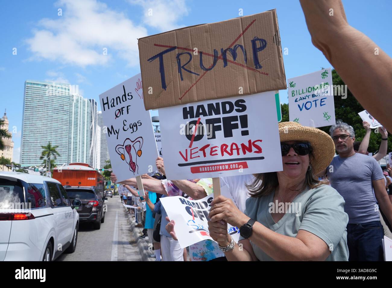 People carry signs and chant slogans during a protest against the ...