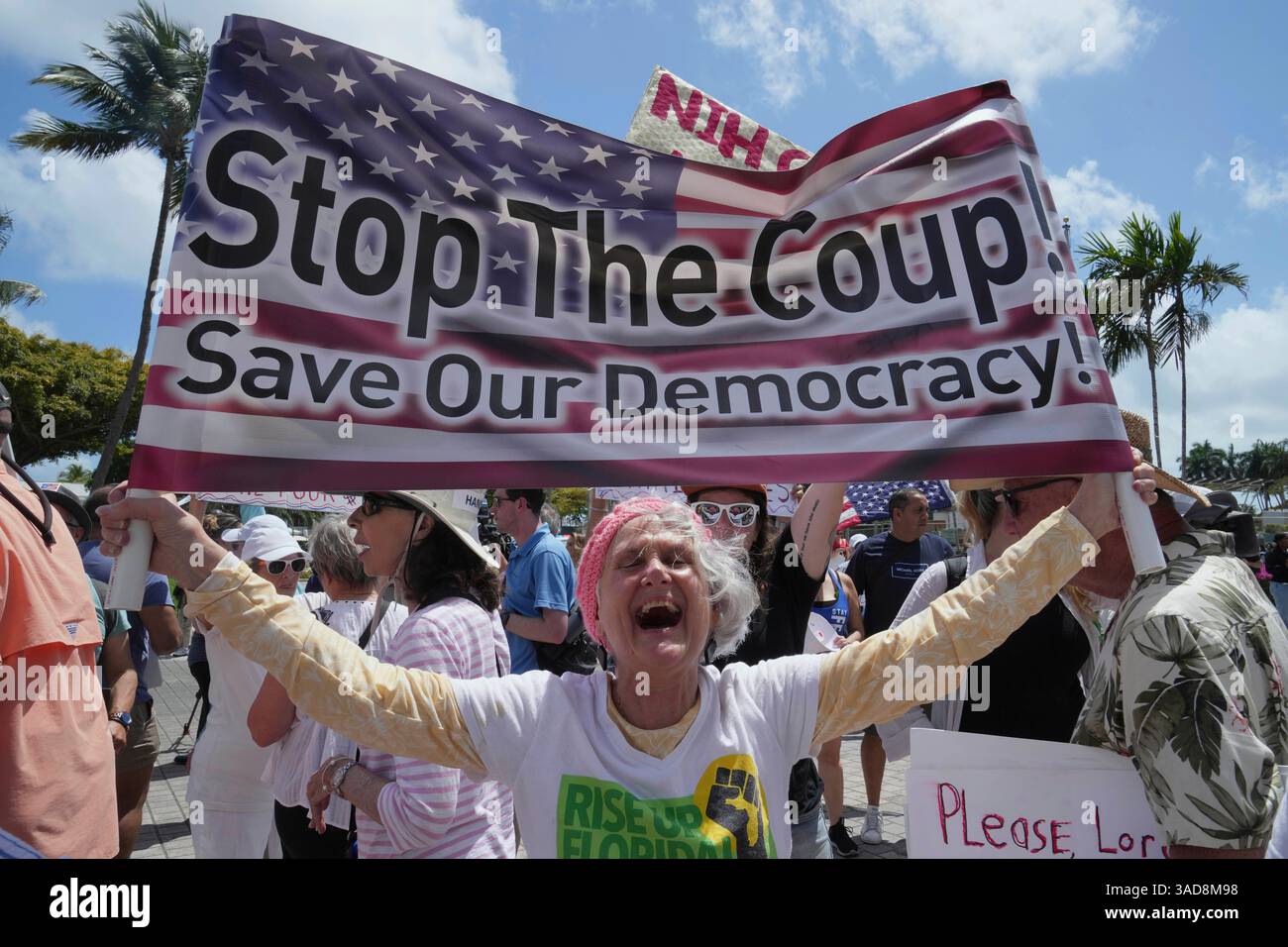 Protesters carry signs and chant slogans against the policies of ...