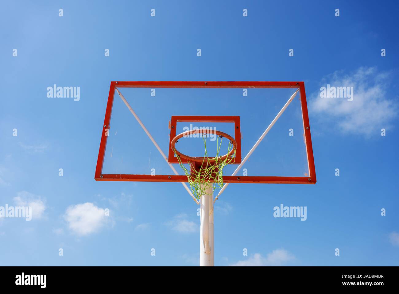 Outdoor orange basketball hoop with blue cloud sky. High quality photo ...