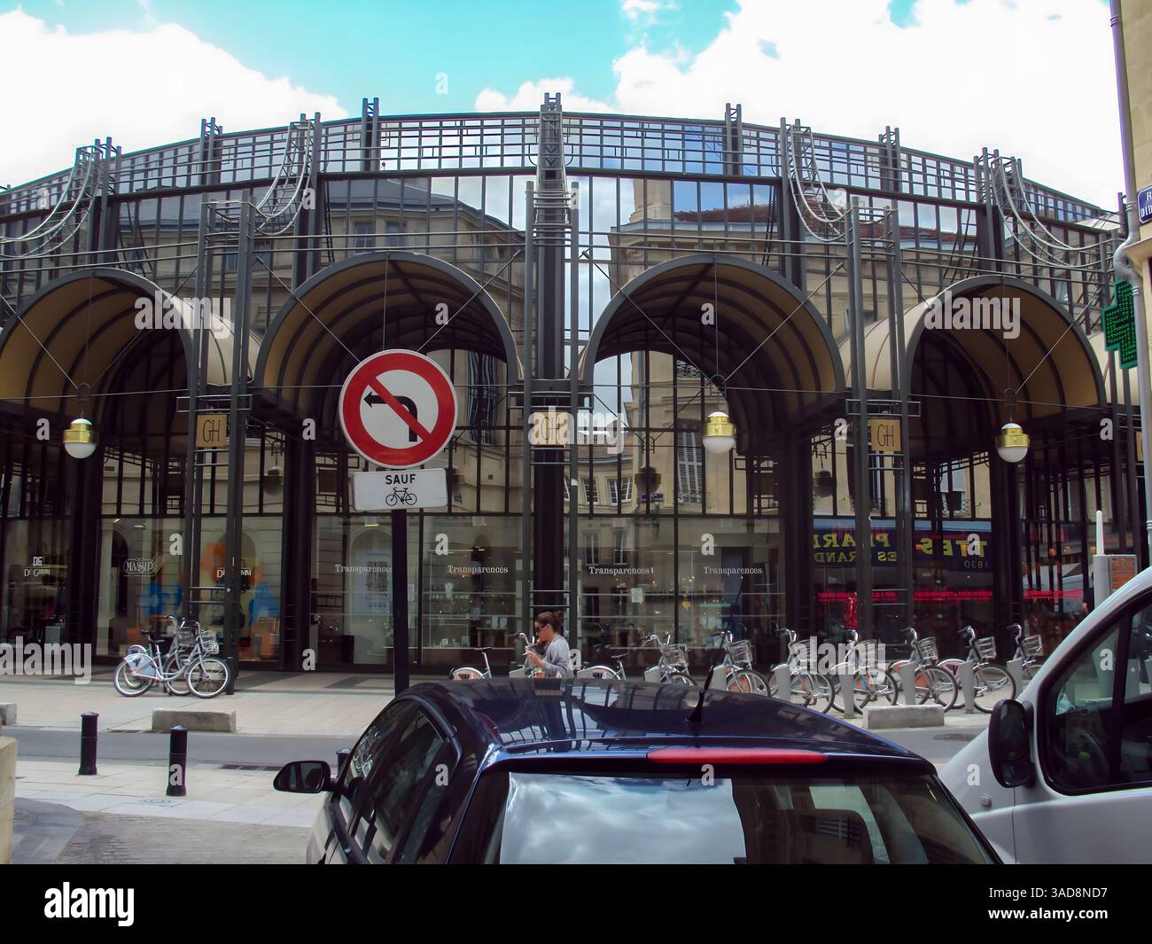 A modern architectural structure featuring large arches and glass ...
