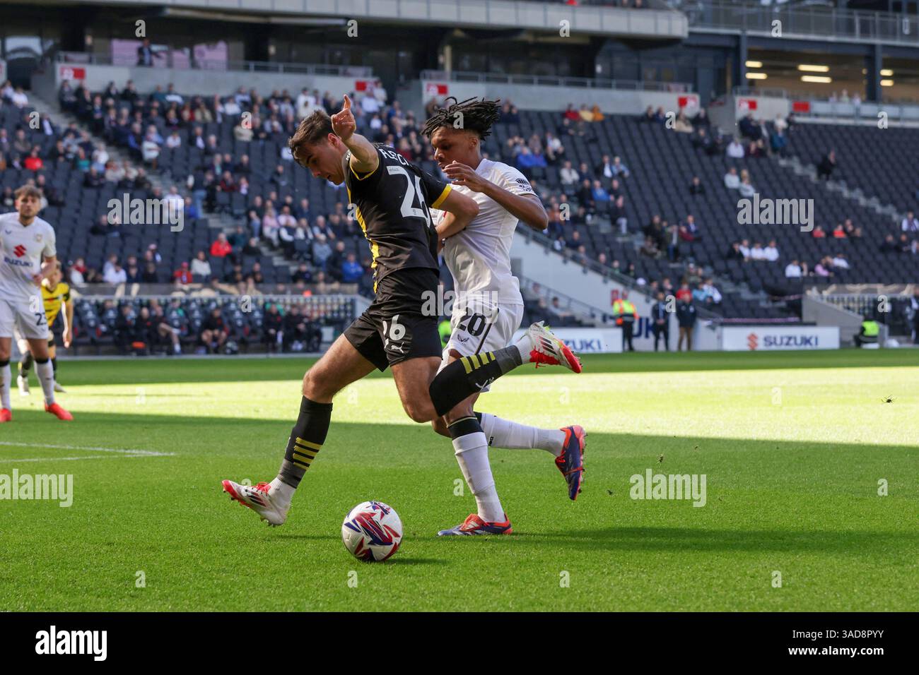 Barrow's Isaac Fletcher is challenged by MK Dons Kane Thompson-Sommers ...