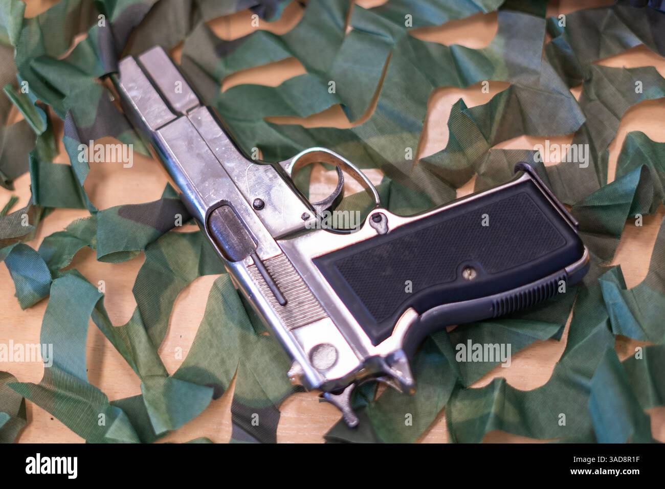Metal-colored Hungarian 96M semi-automatic pistol on a camouflage ...