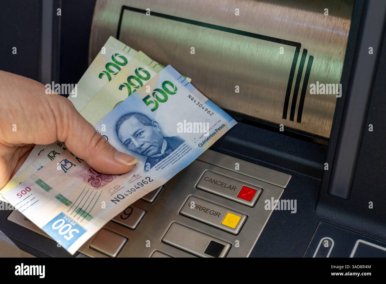 Mexico money. A woman withdraws money from an ATM. Financial concept ...