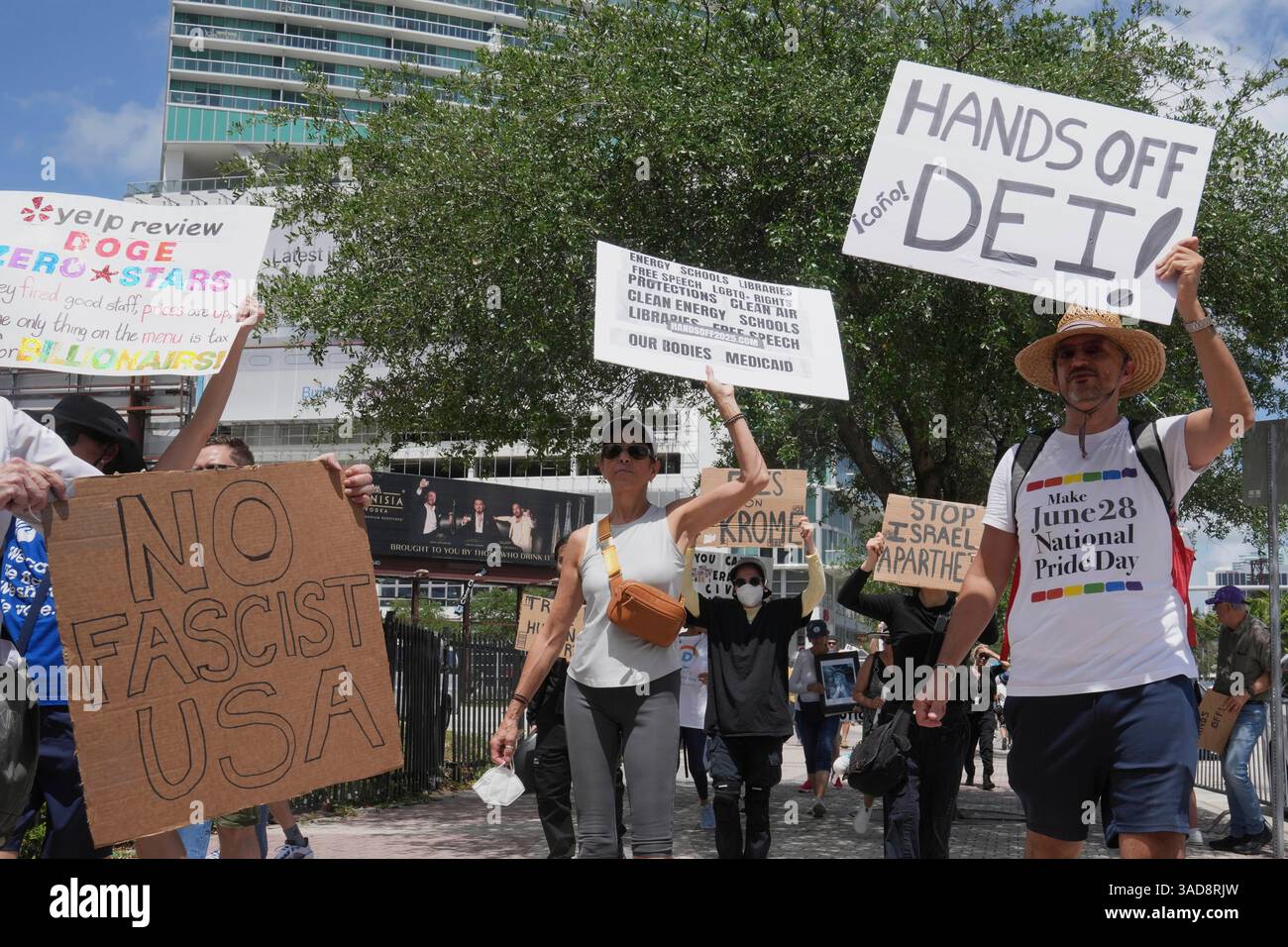 Protesters carry signs and chant slogans against the policies of ...