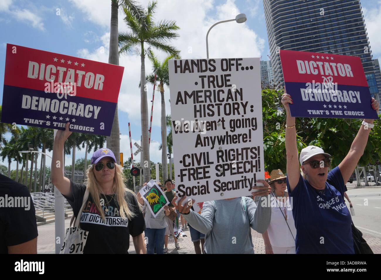 Protesters carry signs and chant slogans against the policies of ...