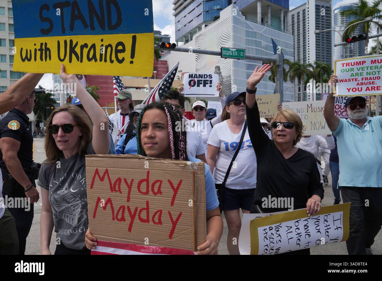 Protesters carry signs and chant slogans against the policies of ...
