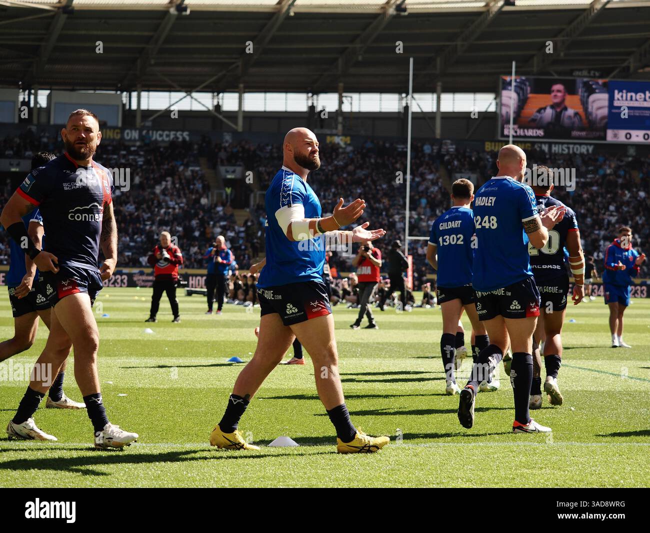 A Hull KR player signalling to the crowd to make more sound before the ...