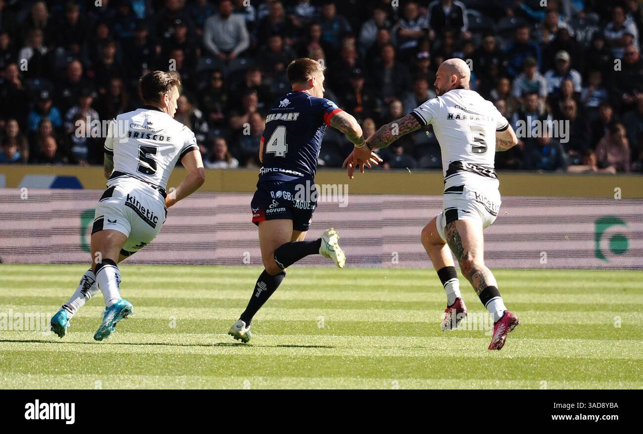 Oliver Gildart of Hull KR runs forward as Tom Briscoe of Hull FC and ...