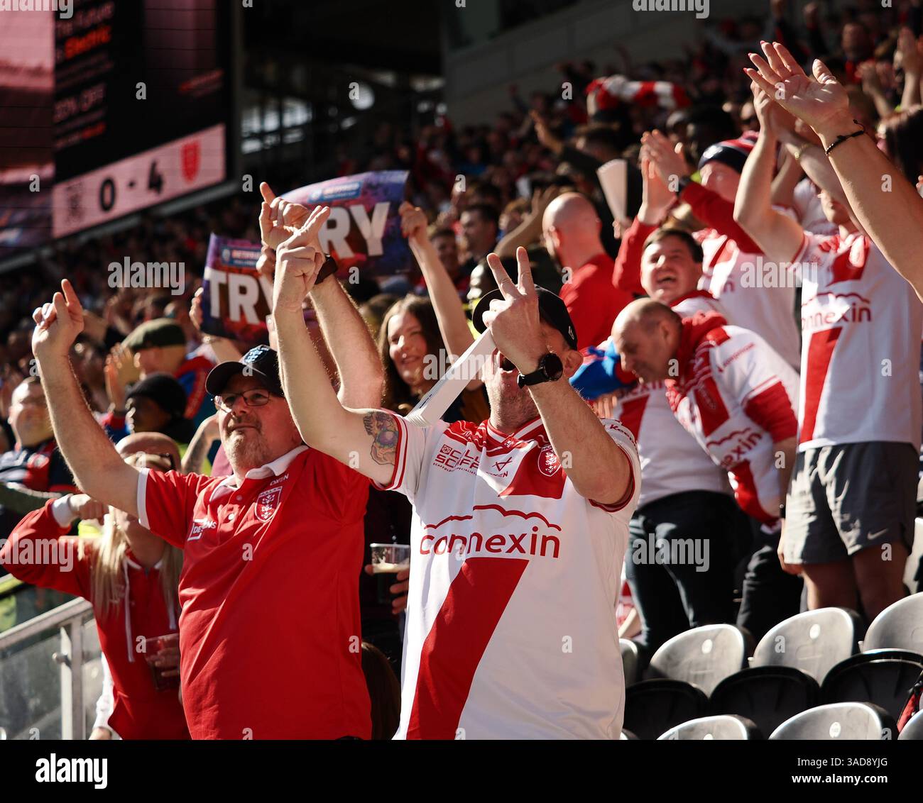 Two Hull K.R. fans make signs towards the Hull F.C. fans after a try ...