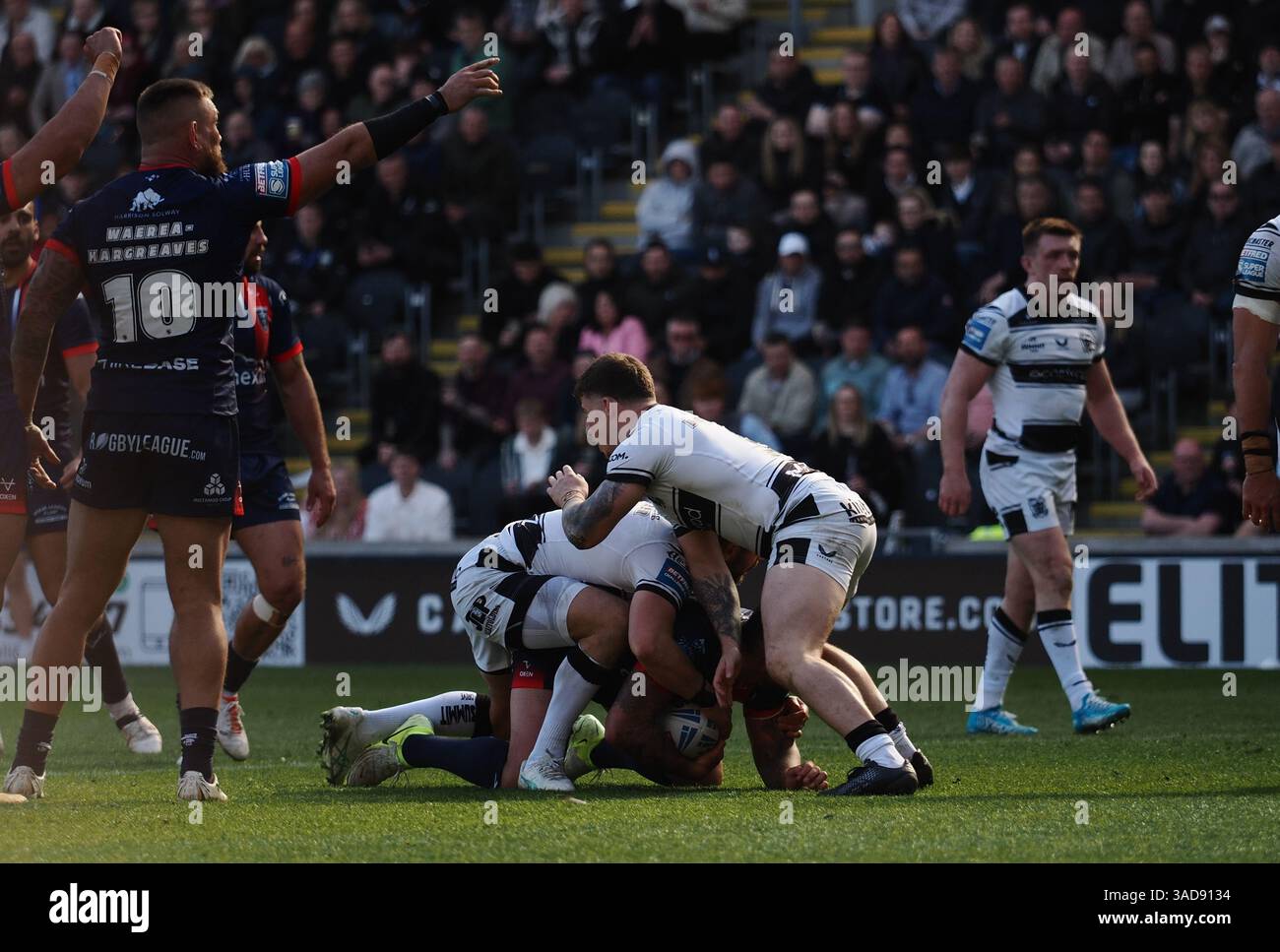 Hull F.C. players pile on a Hul K.R. player during the Betfred ...