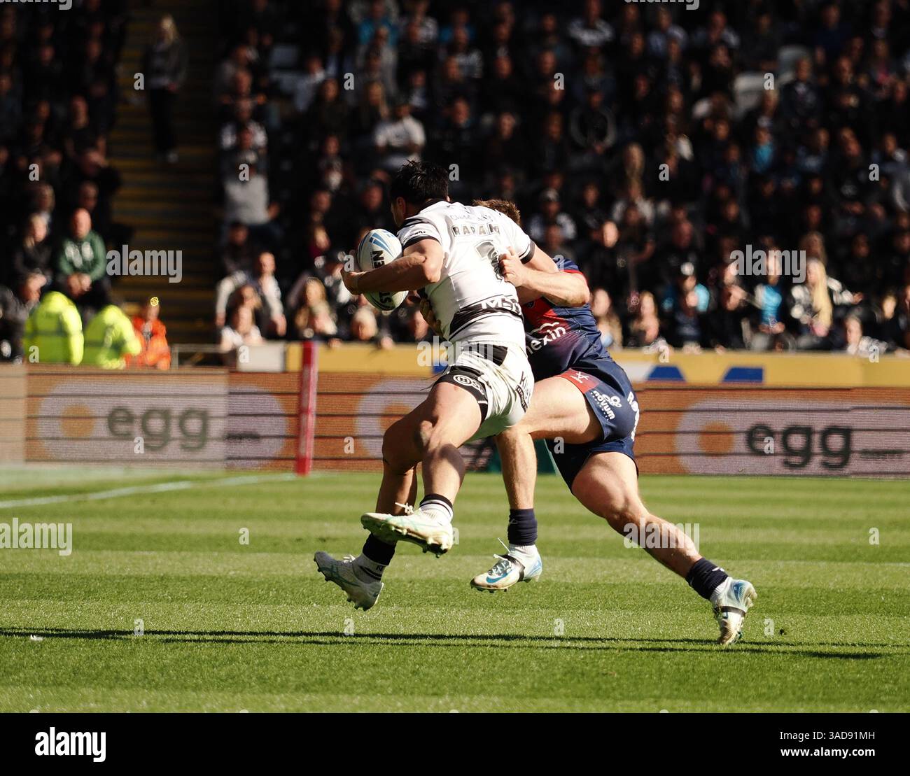 Jordan Rapana of Hull FC gets tackled by a Hull KR player during the ...