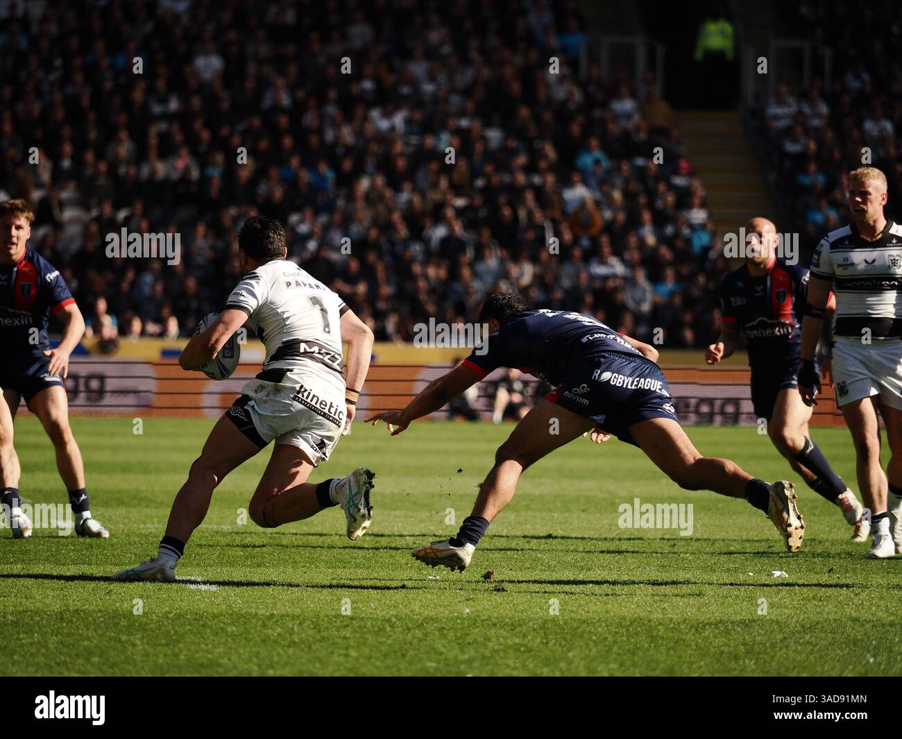 Jordan Rapana of Hull FC pushes forward leaving a Hull K.R player ...