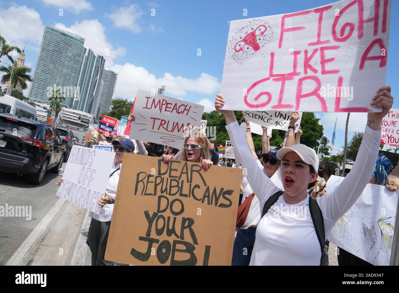 Protesters carry signs and chant slogans against the policies of ...