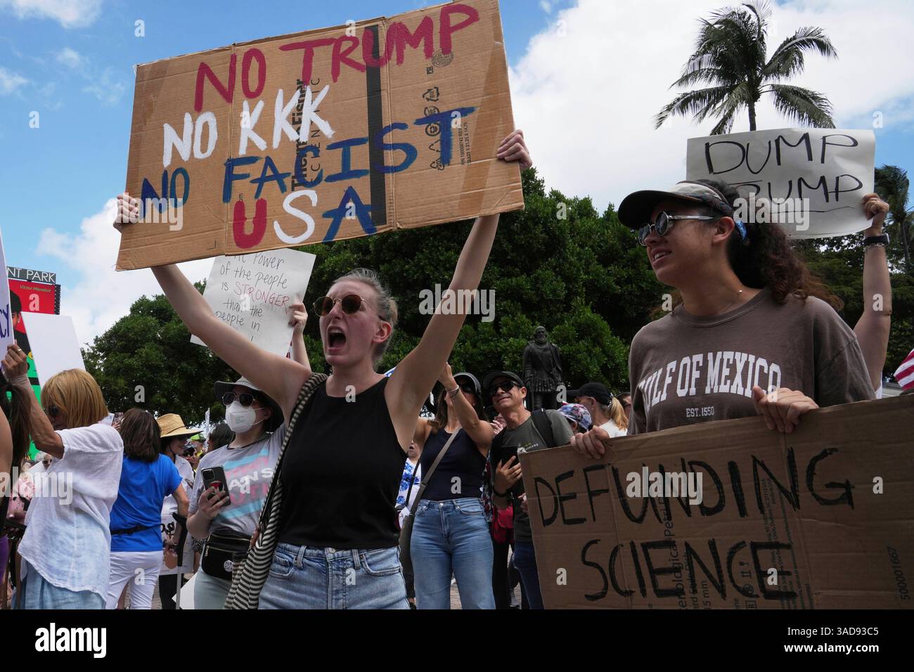 Protesters carry signs and chant slogans against the policies of ...