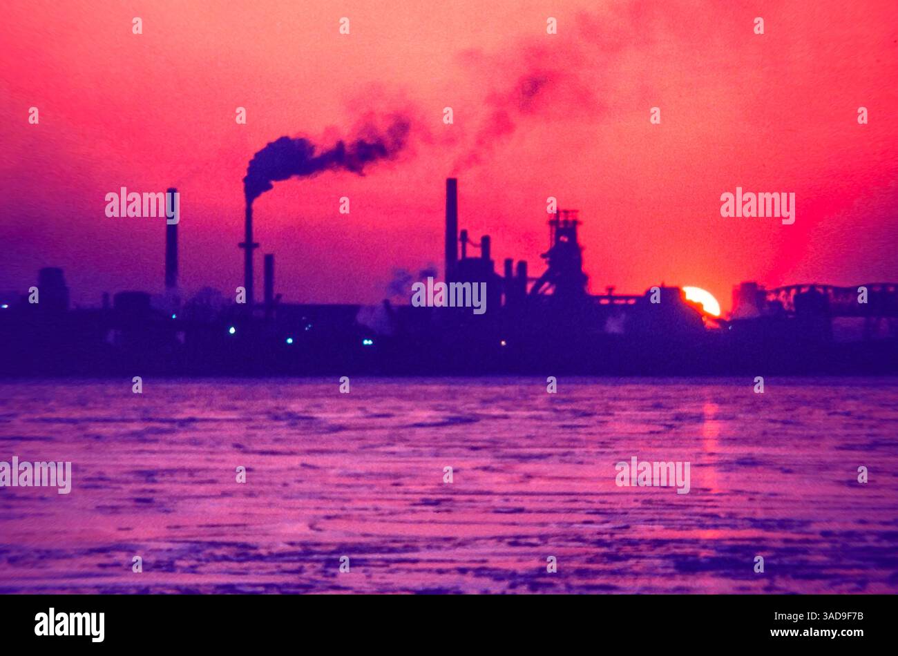 Steel Mill Smoke Stacks in red & purple sunset on the waterfront Stock ...