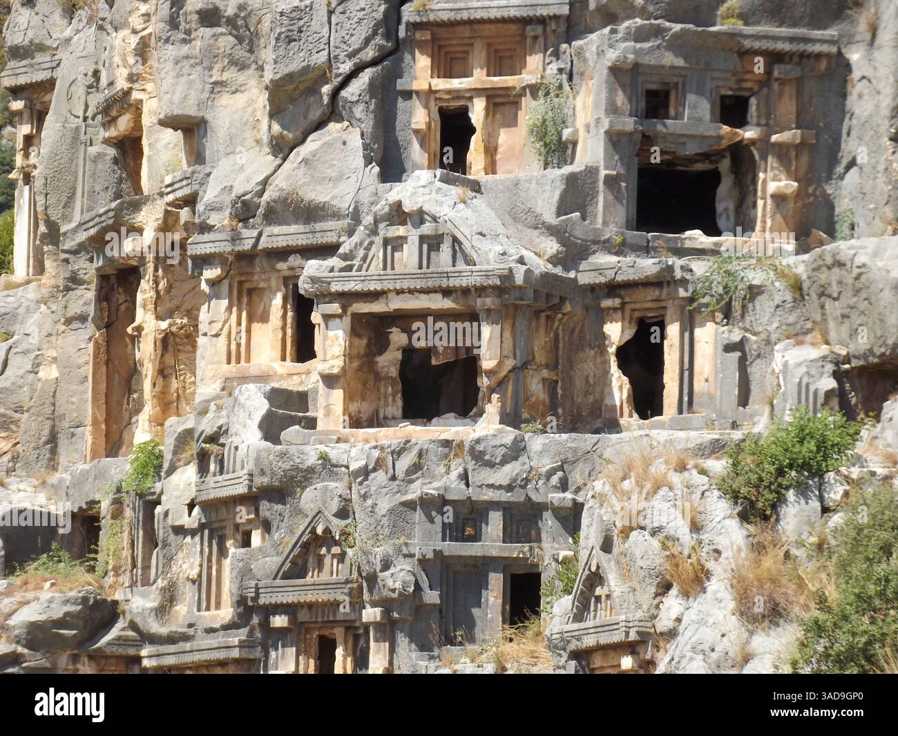 Ancient rock-cut tombs carved into a cliffside, showcasing intricate ...