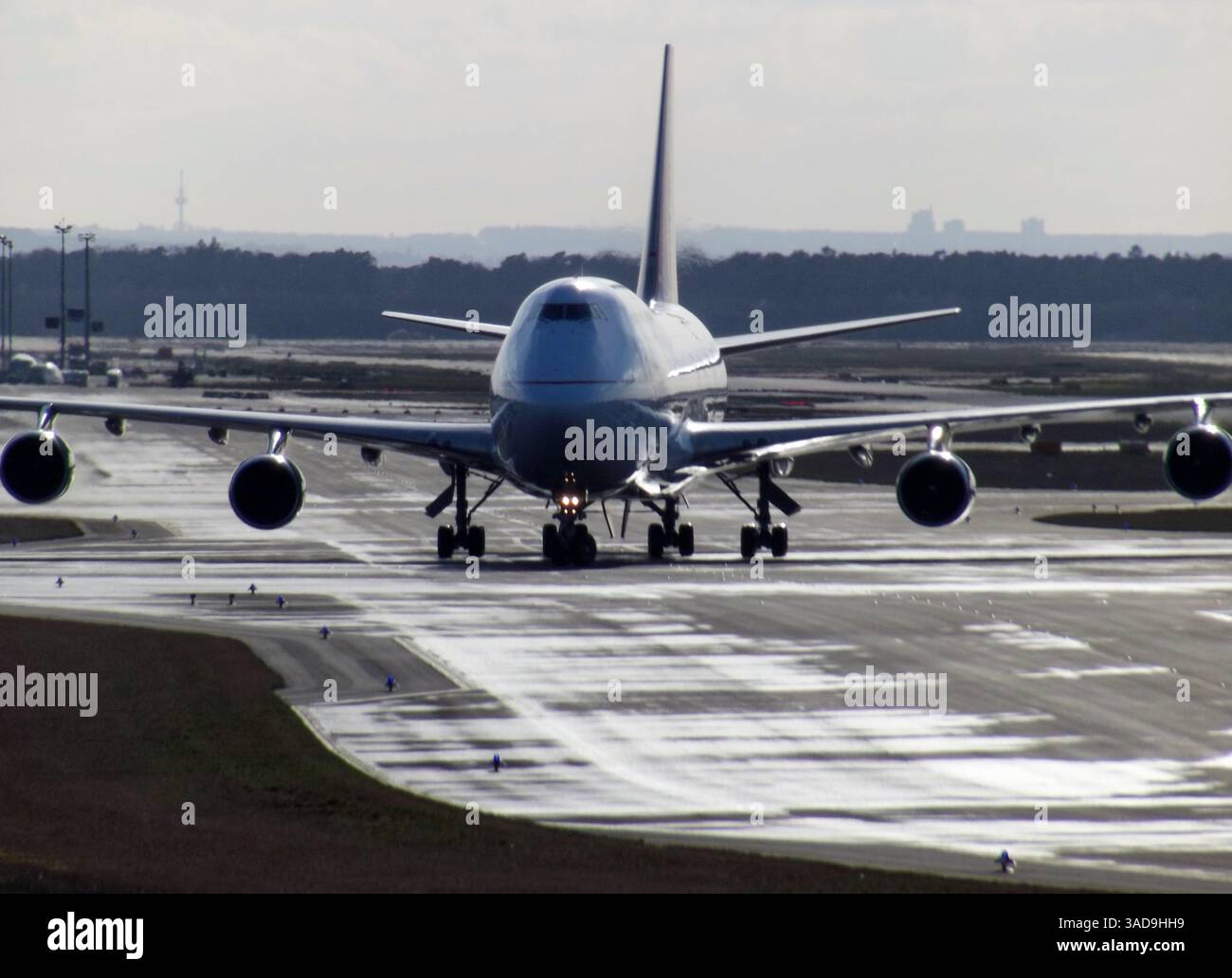 A large passenger airplane, possibly a Boeing 747, is taxiing on a ...
