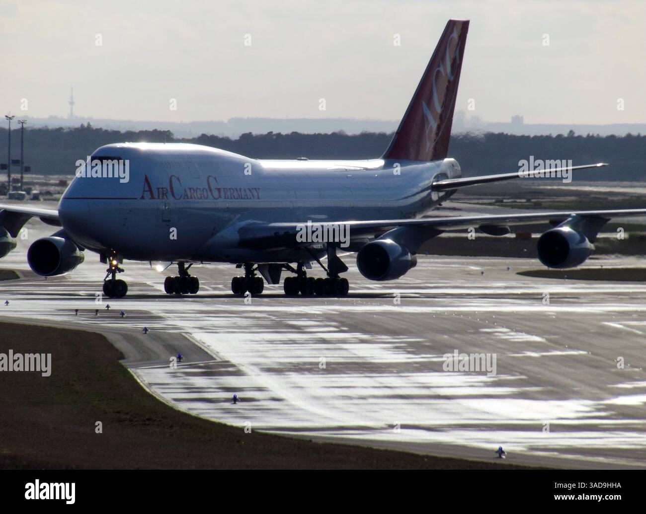A large cargo airplane, specifically a Boeing 747, taxiing on a wet ...