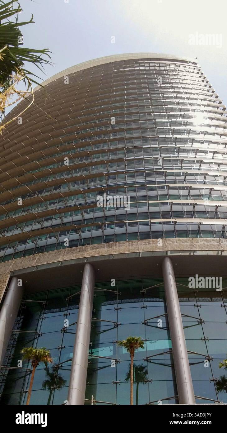 A modern, curved skyscraper with a glass facade, featuring multiple ...