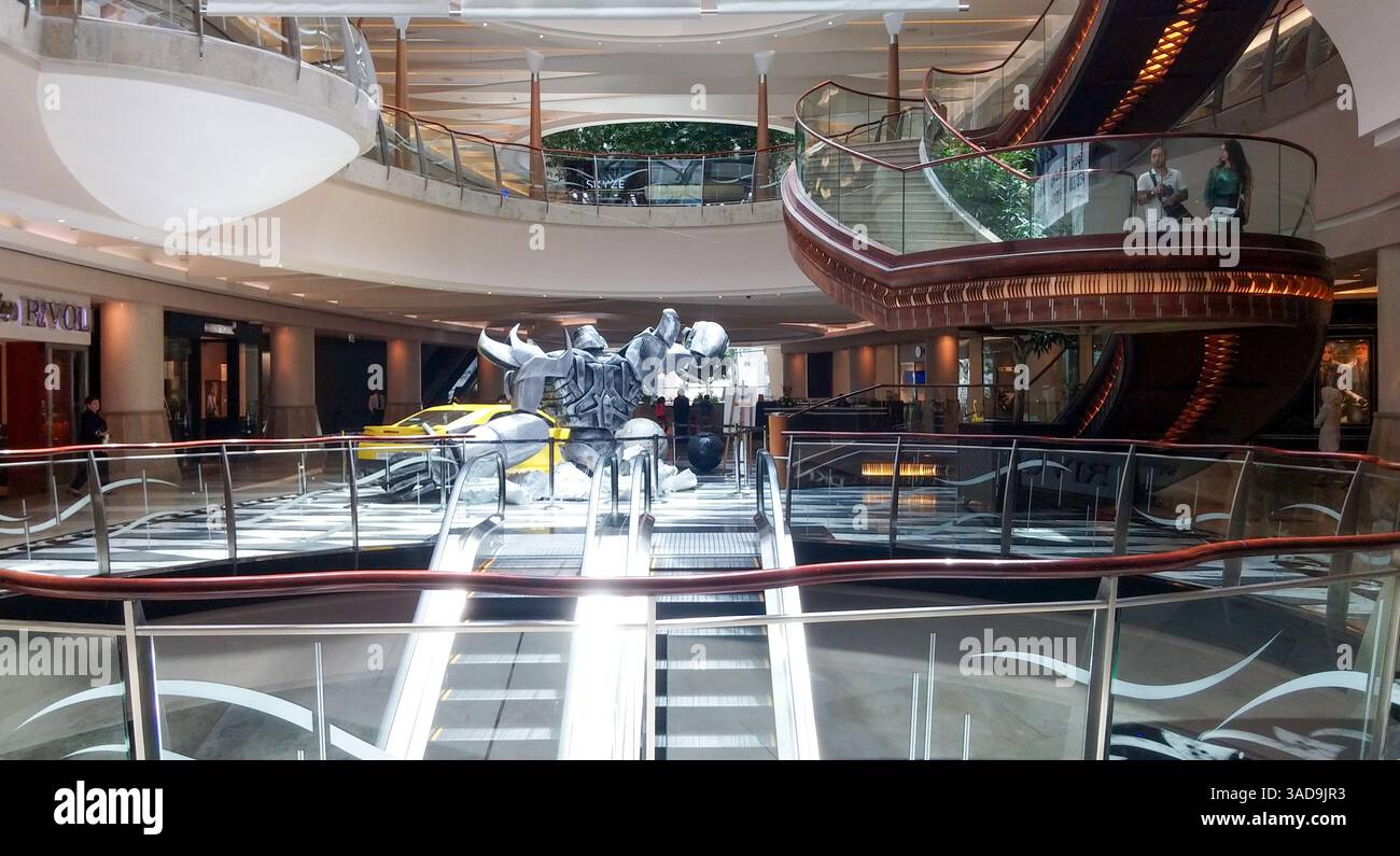 A modern shopping mall interior featuring a striking sculpture in the ...