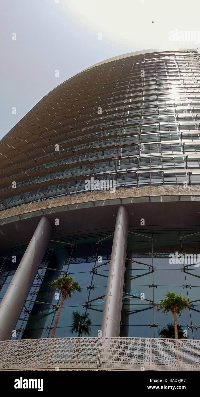 A modern skyscraper with a curved glass facade, showcasing a unique ...